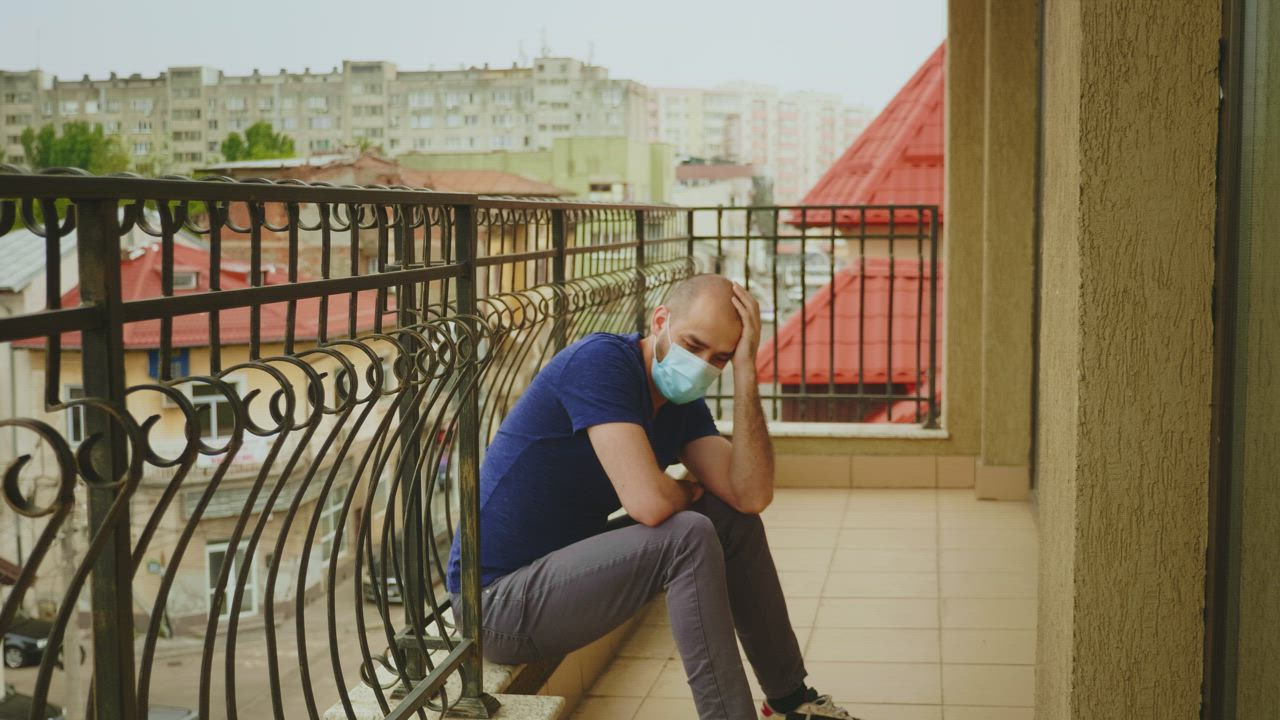 Depressed man wearing mask sits on balcony in Covid lockdown - Free ...