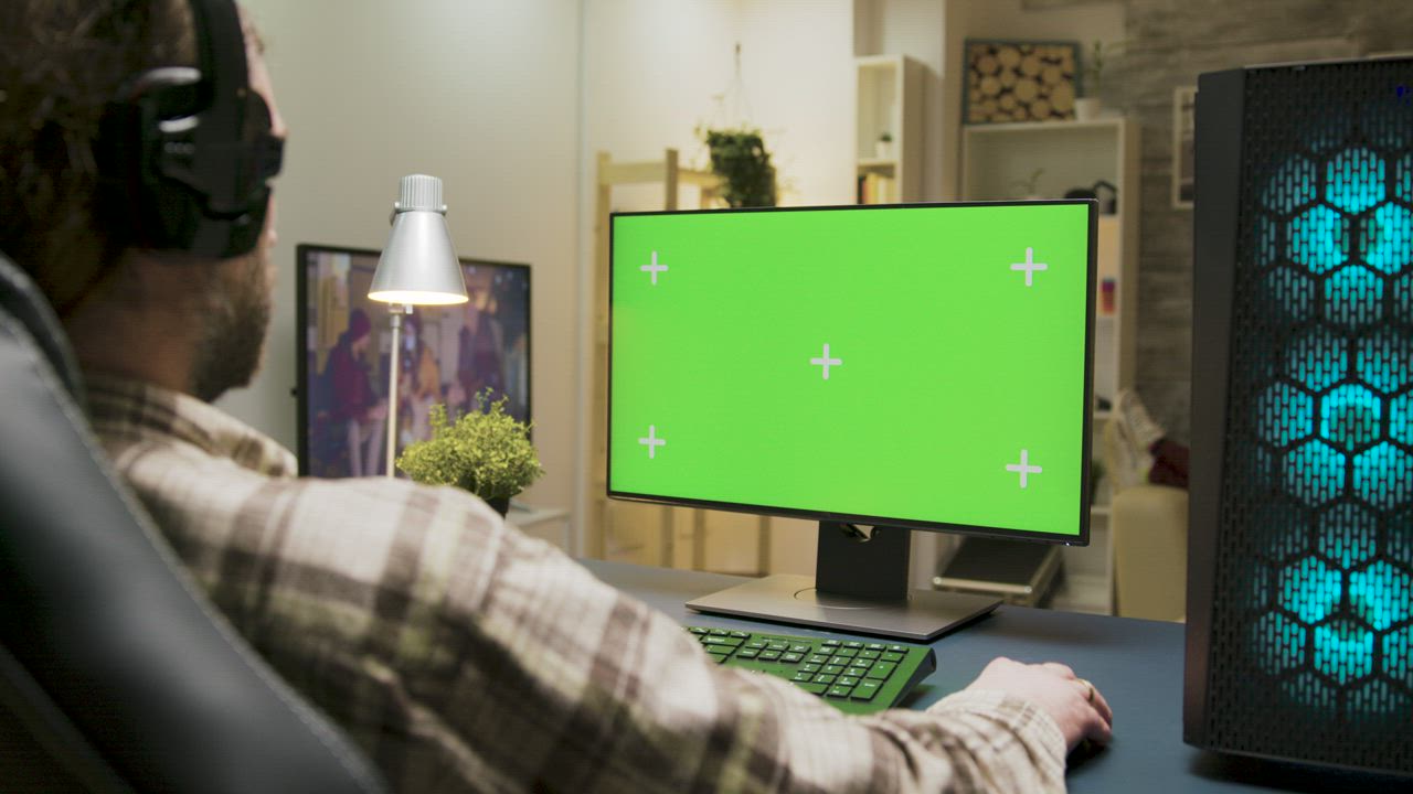 Man gaming at home with green screen monitor - Free Stock Video