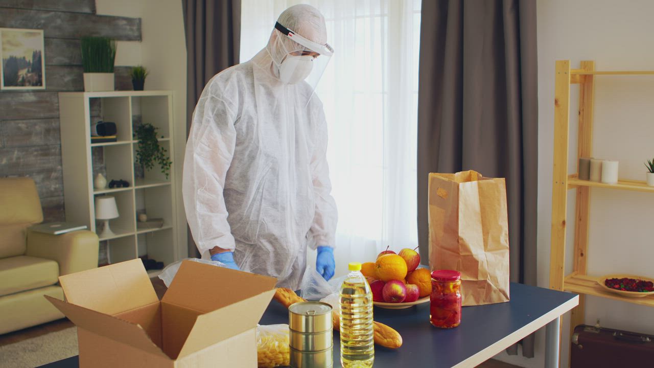Packing groceries in PPE for coronavirus safety - Free Stock Video