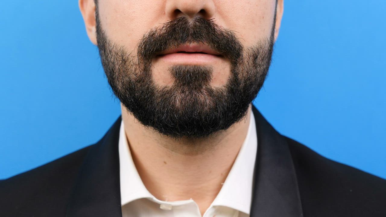 Bearded man smiles and shows teeth - Free Stock Video