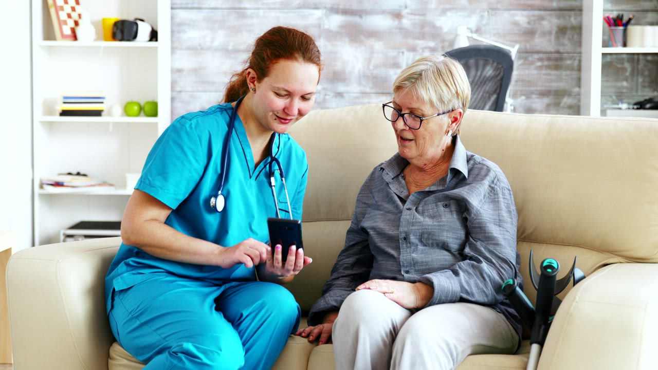 Nurse sitting with a patient - Free Stock Video