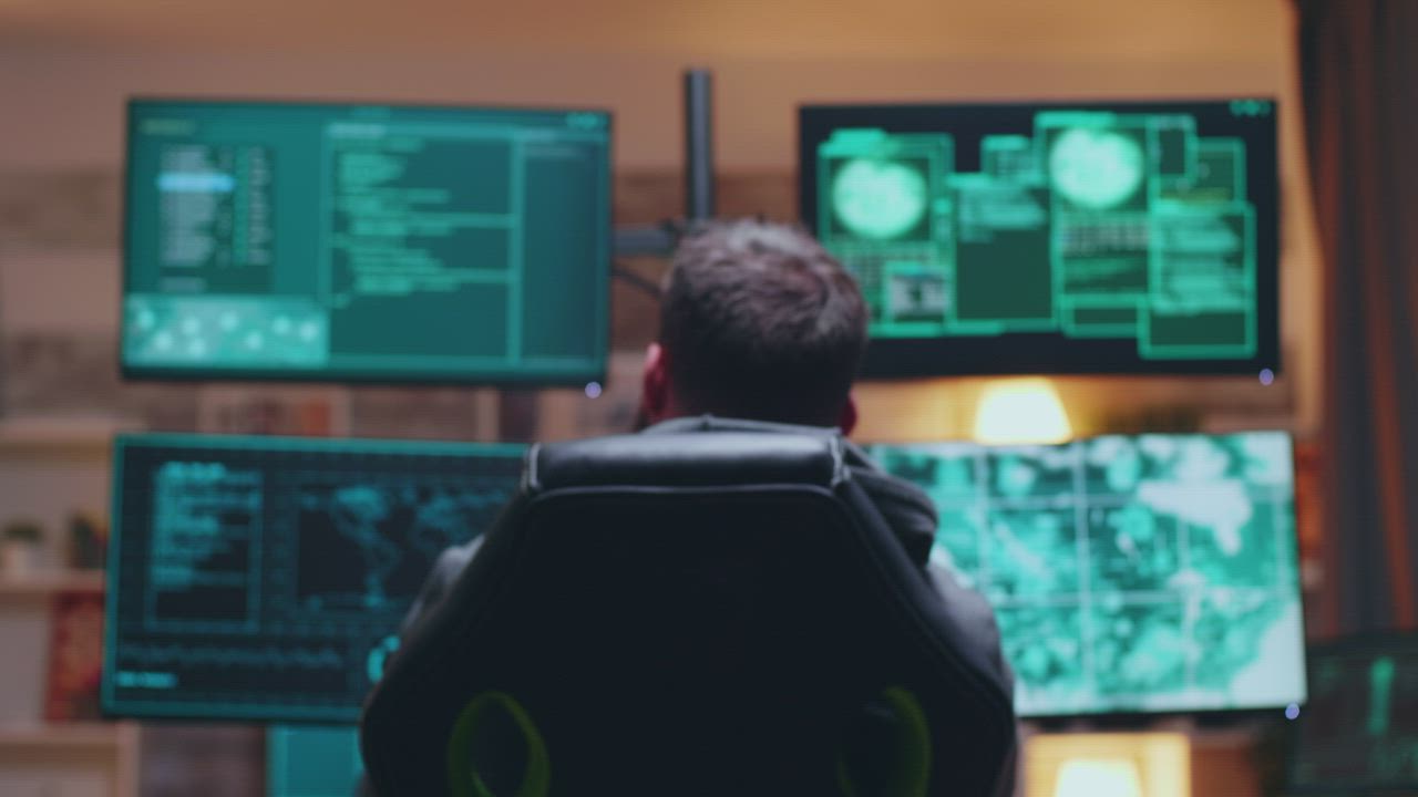 Male hacker sitting at his desk - Free Stock Video
