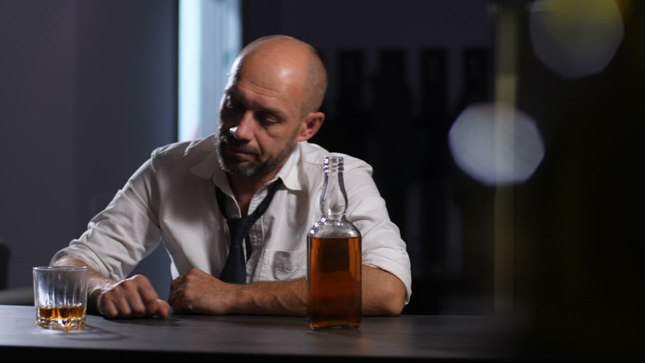 Tired man drinking whisky - Free Stock Video