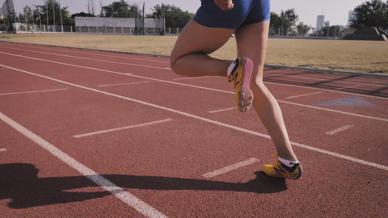 Runner on a track in slow motion - Free Stock Video