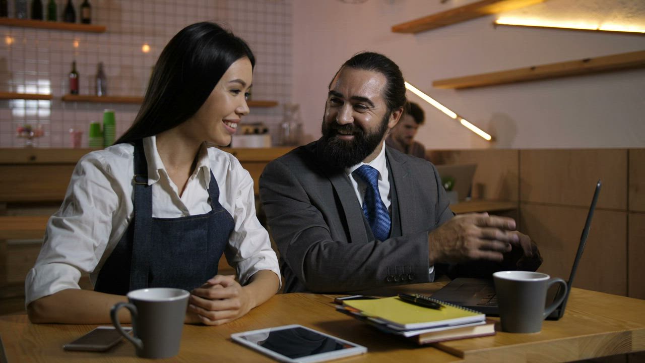 Manager enjoying a chat with his staff - Free Stock Video