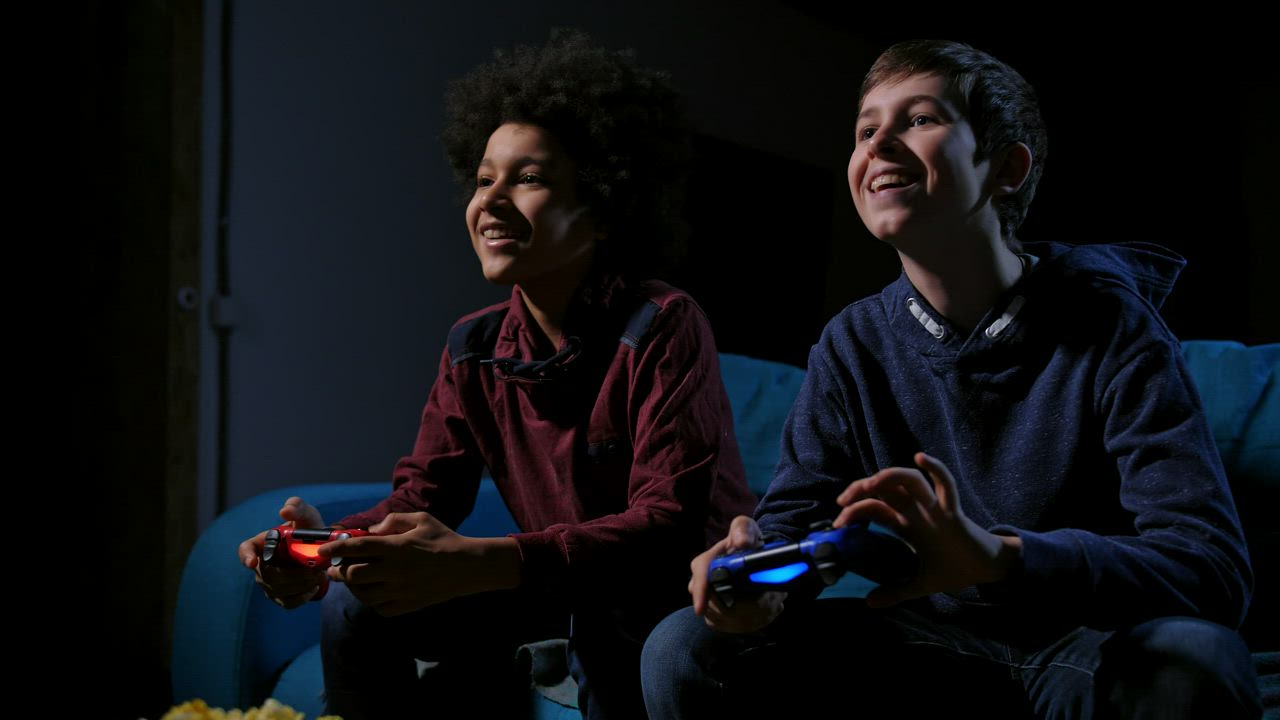 Boys playing video games at night - Free Stock Video