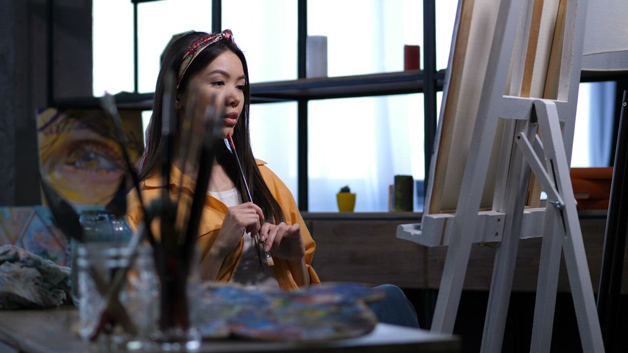 Artist looking at her painting - Free Stock Video