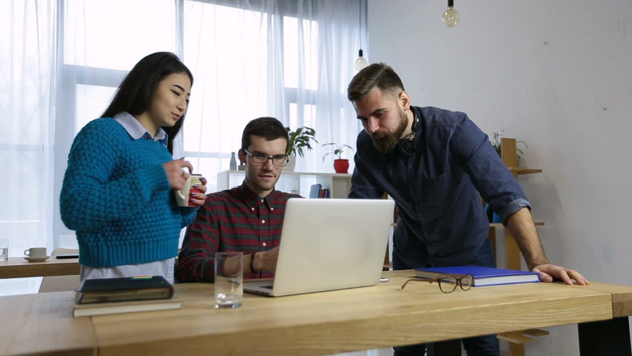 Team working on a laptop - Free Stock Video