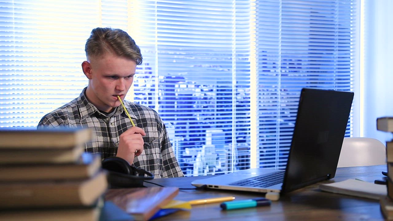 Student stuck on his work - Free Stock Video