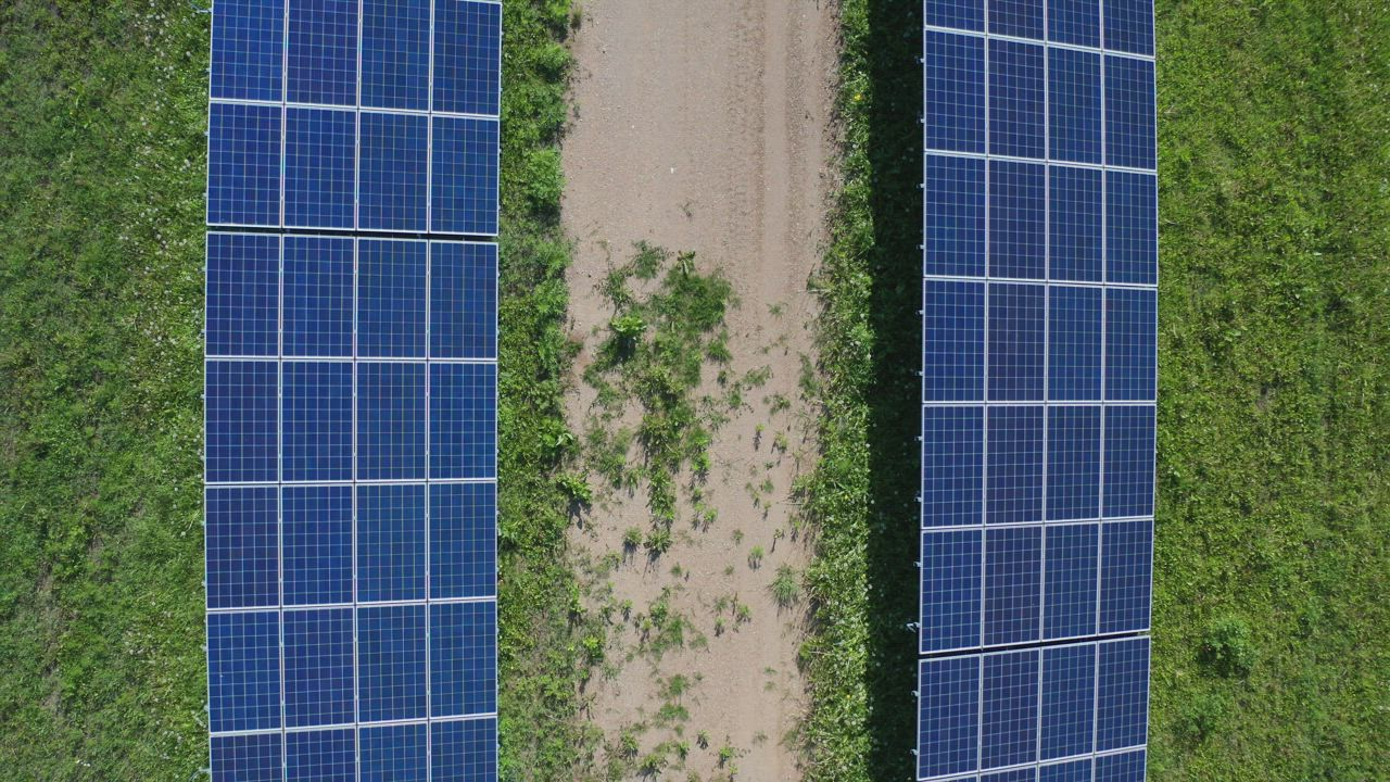 Solar panels in a field - Free Stock Video