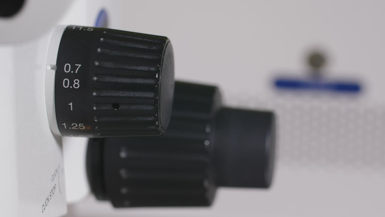Adjusting the zoom on a microscope - Free Stock Video