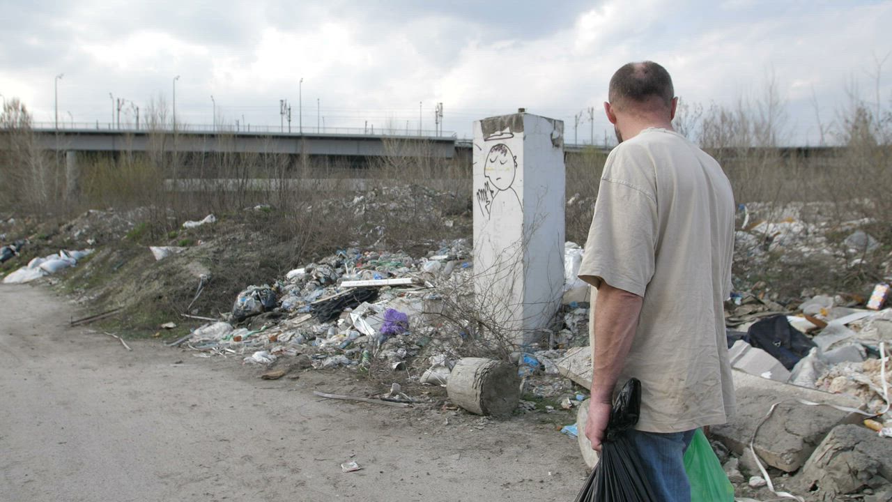 Poor man carrying trash bags - Free Stock Video