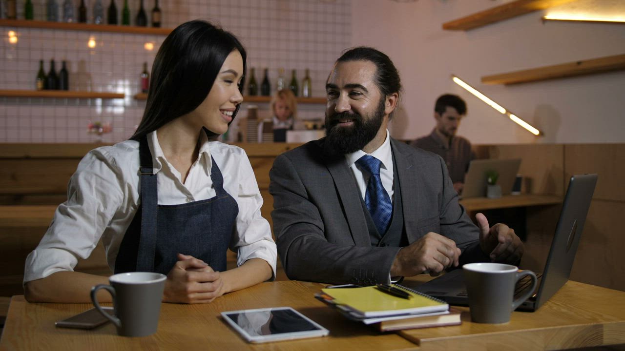 Cafe owner interviewing remotely - Free Stock Video