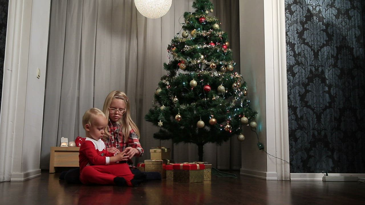 Children opening gifts on Christmas morning - Free Stock Video