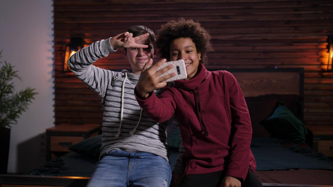 Two friends playing with a phone camera - Free Stock Video