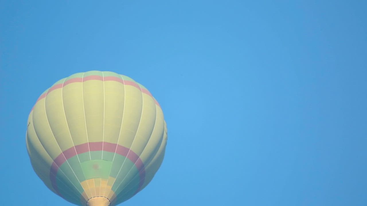 Air balloon rising in the clear sky - Free Stock Video