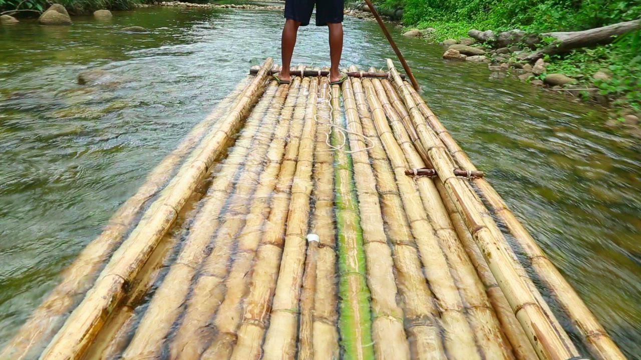 Down the river in a bamboo canoe - Free Stock Video