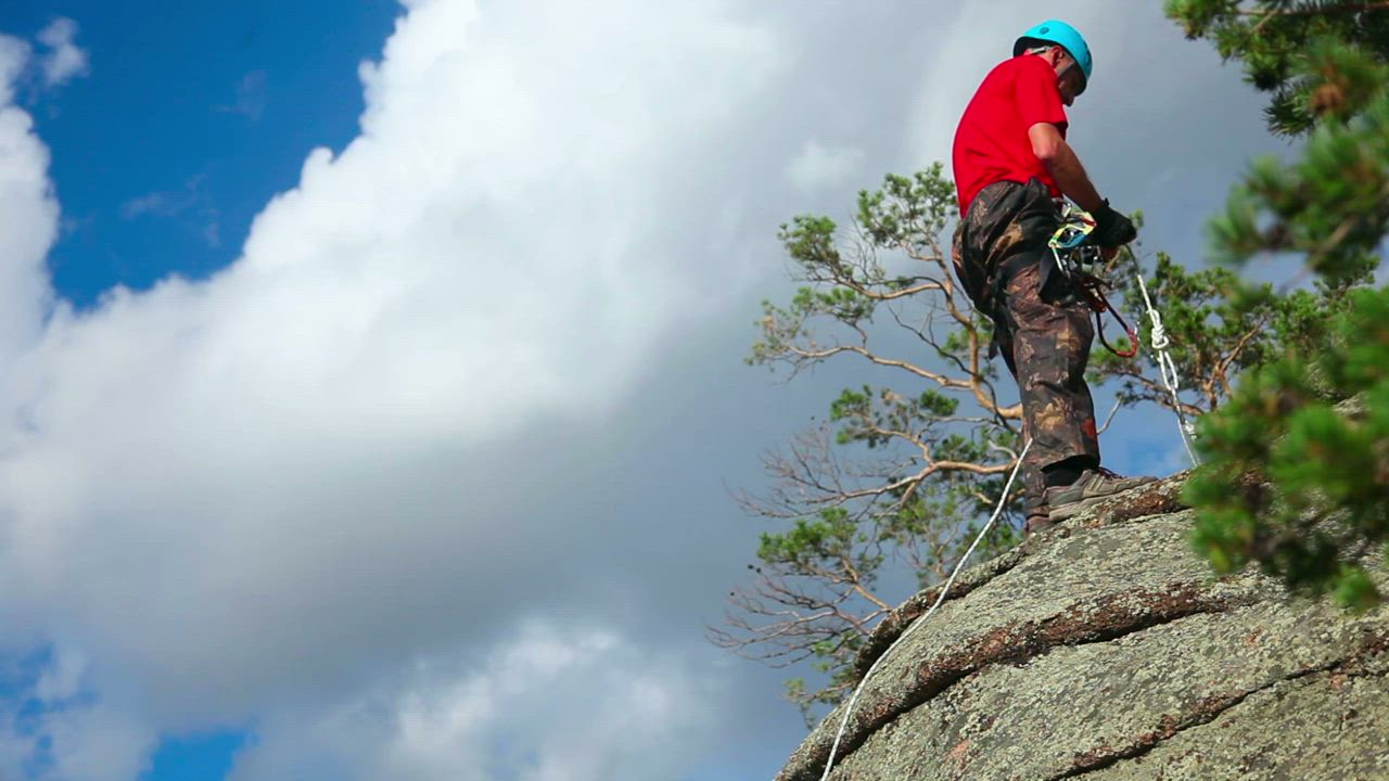 Rock climber descending on rock - Free Stock Video