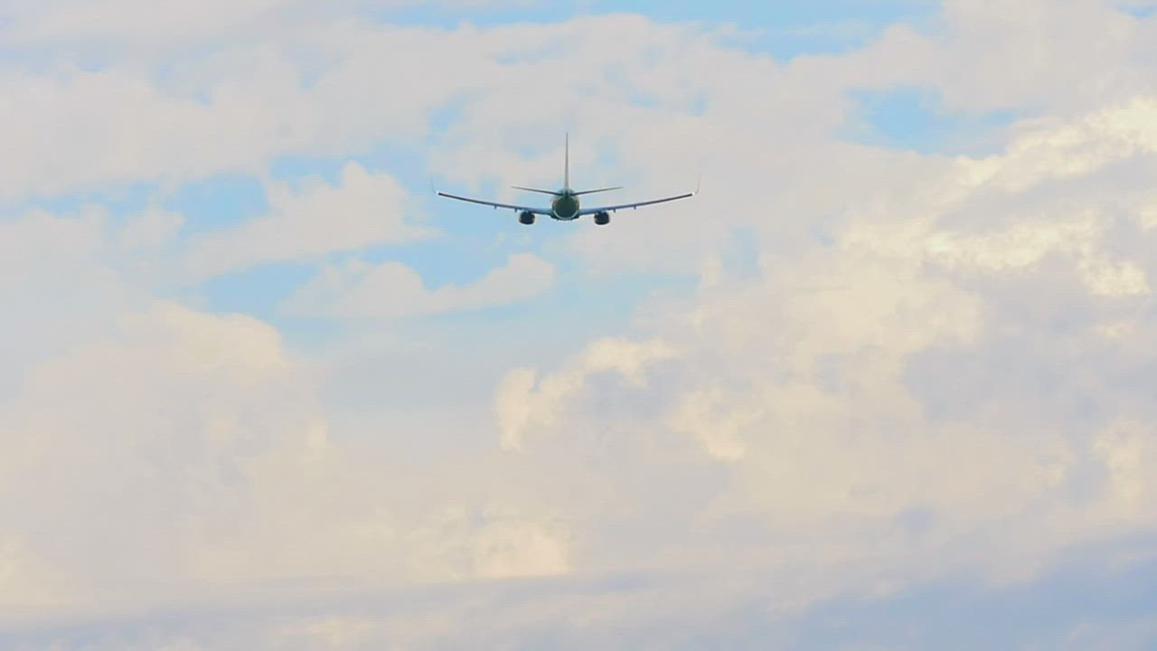 Airplane in the distance flying - Free Stock Video