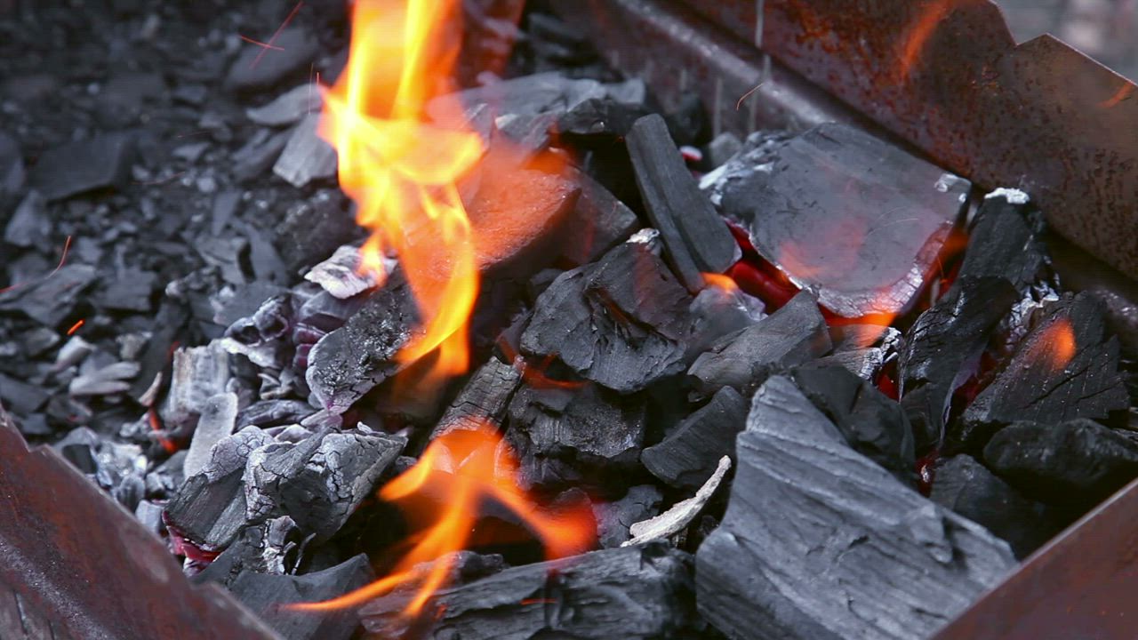 Carbon chunks and flames burning in the brazier - Free Stock Video
