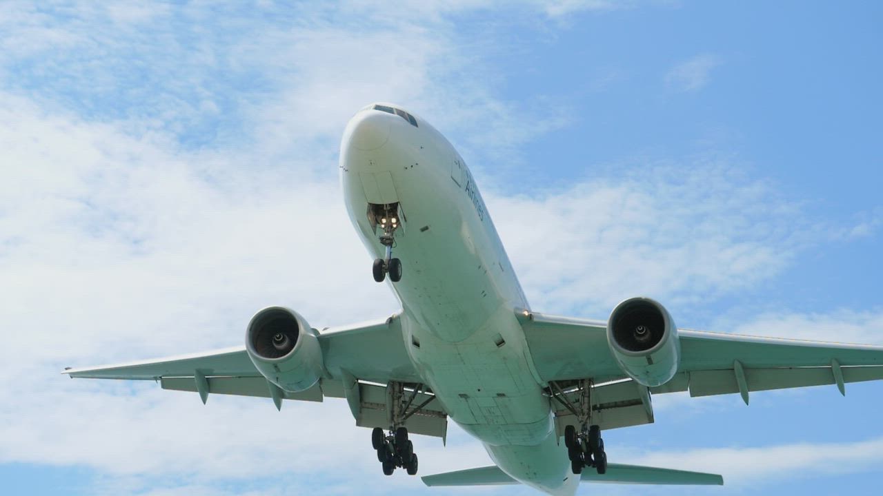 Bottom view of an airplane preparing to land - Free Stock Video
