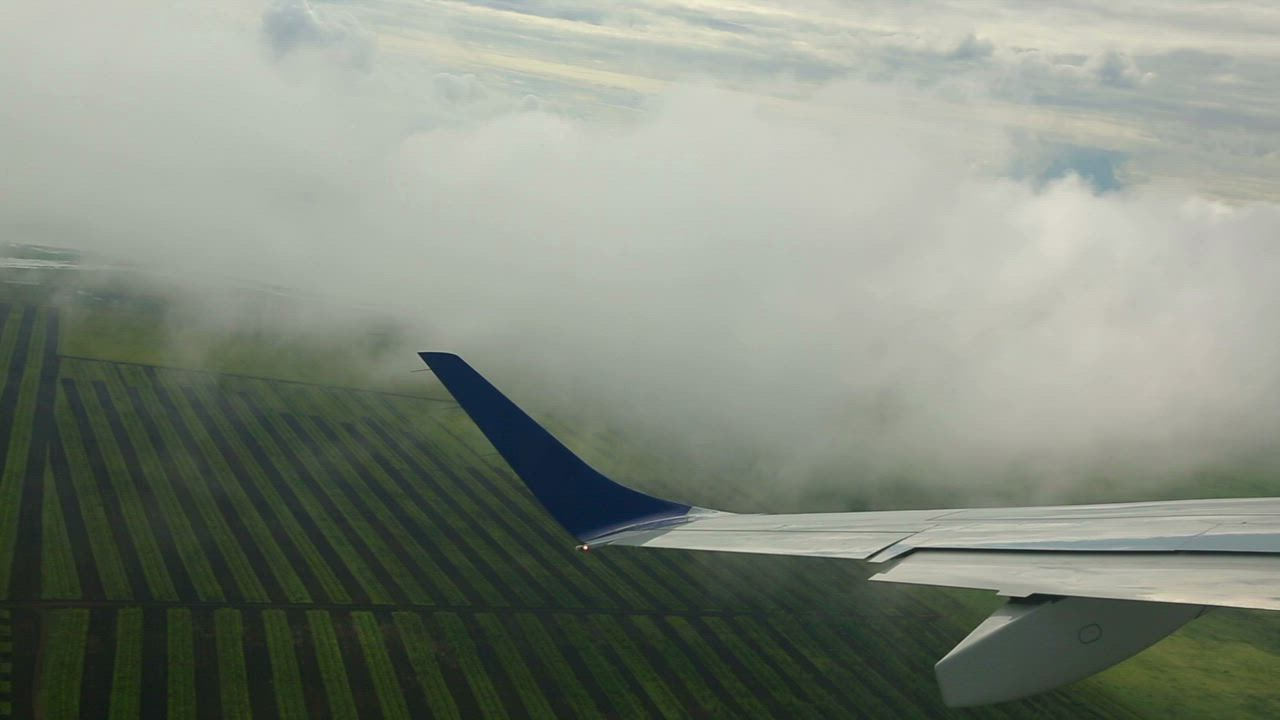 Airplane going through the clouds - Free Stock Video