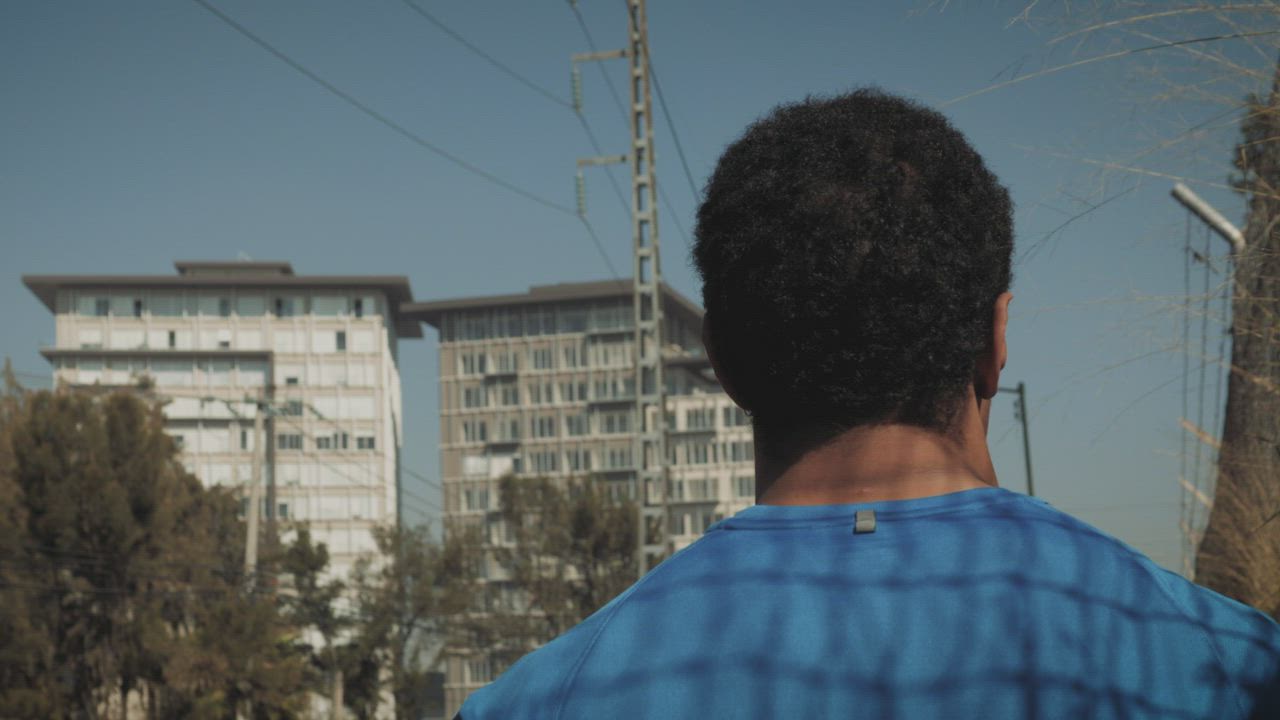 Back view of man running down street - Free Stock Video