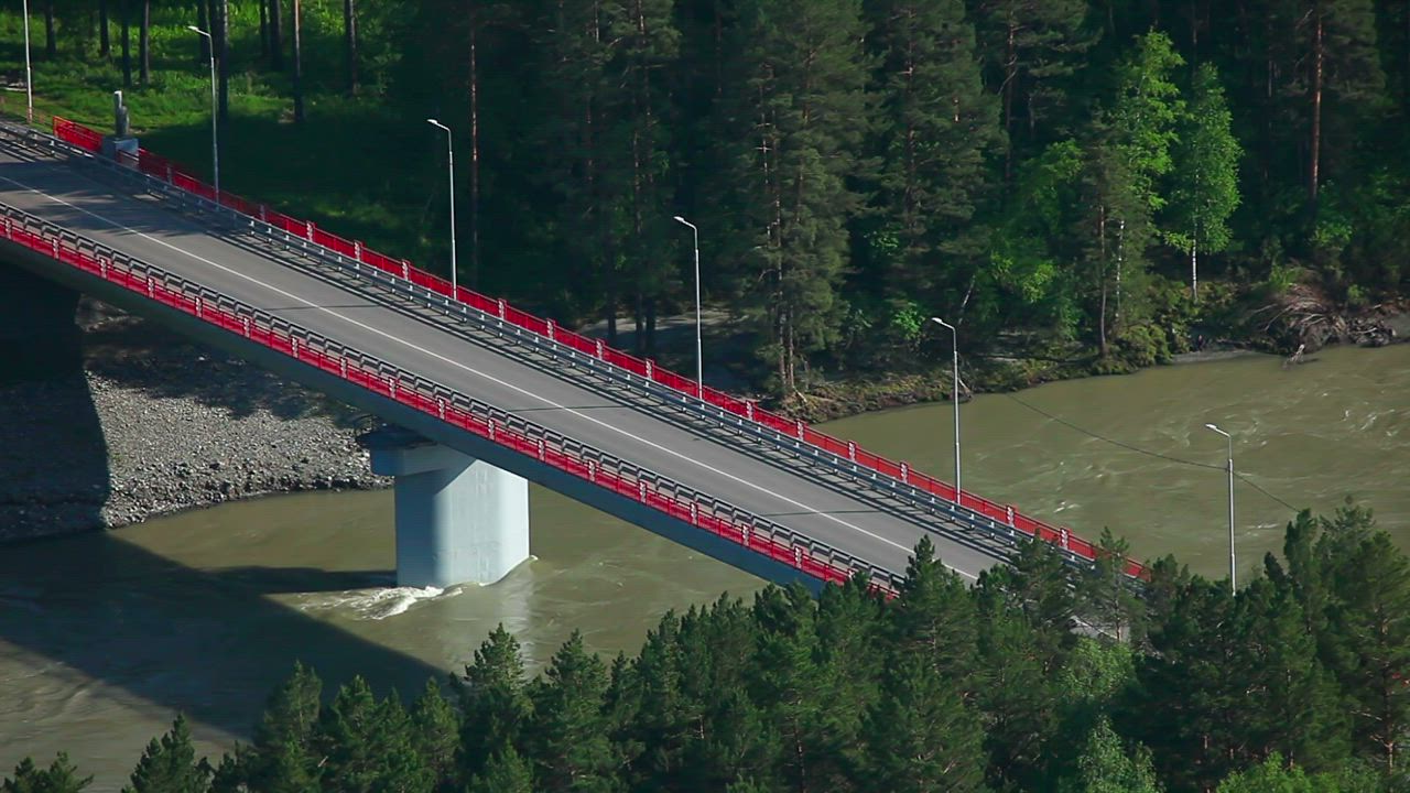 Cars crossing a bridge in the countryside - Free Stock Video