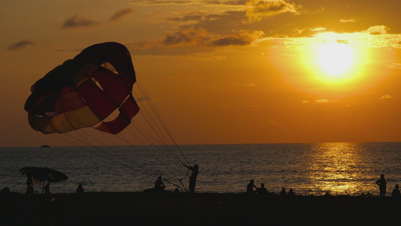 Parachute and sunset at the beach - Free Stock Video
