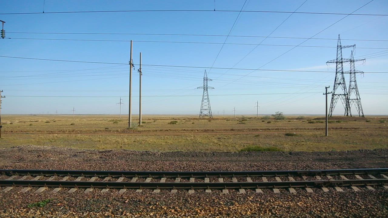 Electric towers from a train in motion - Free Stock Video