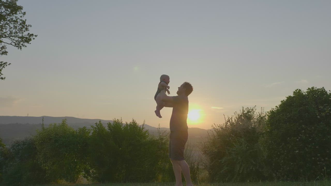 Young baby being raised in the air - Free Stock Video