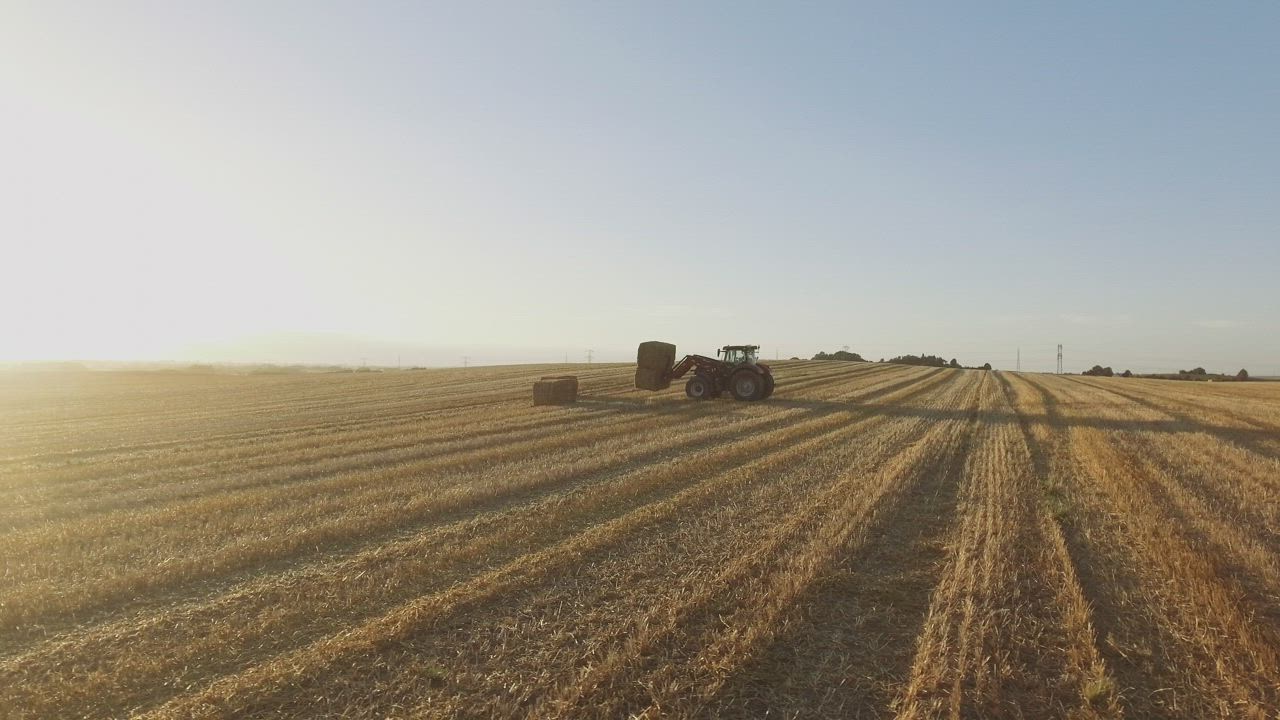 Tractor moving hay - Free Stock Video