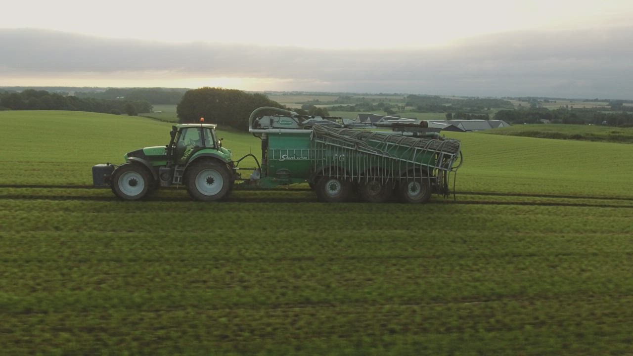 Tractor pulling a water tank - Free Stock Video