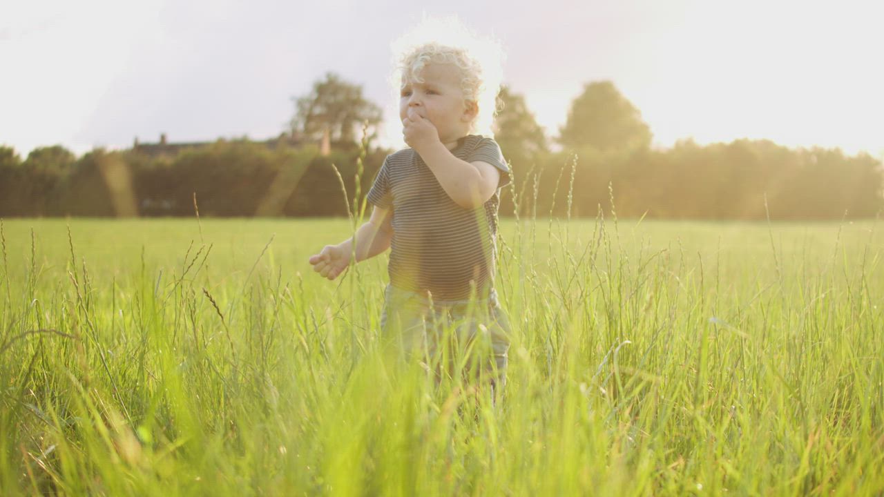 Young boy eating grass - Free Stock Video