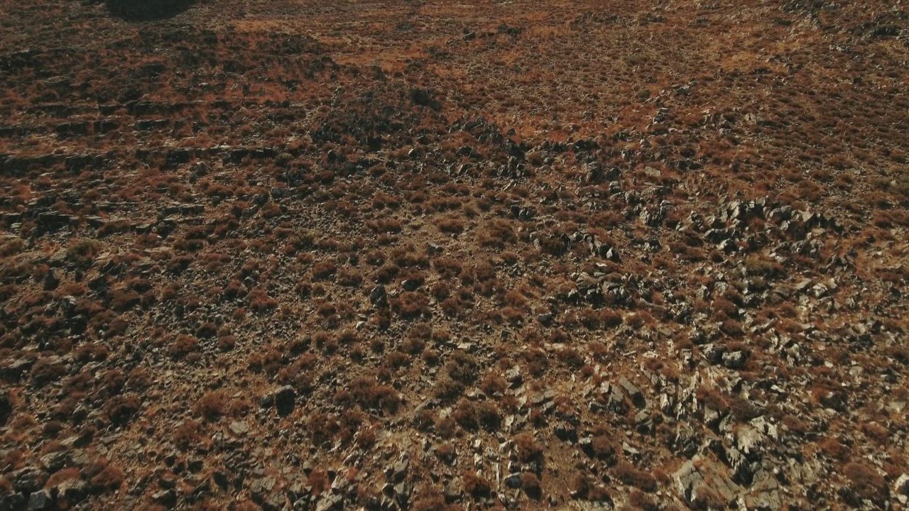 Rocky fields next to a village - Free Stock Video