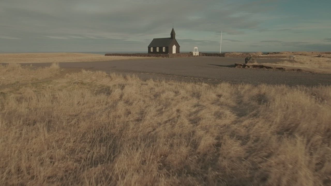 Church by windswept fields - Free Stock Video