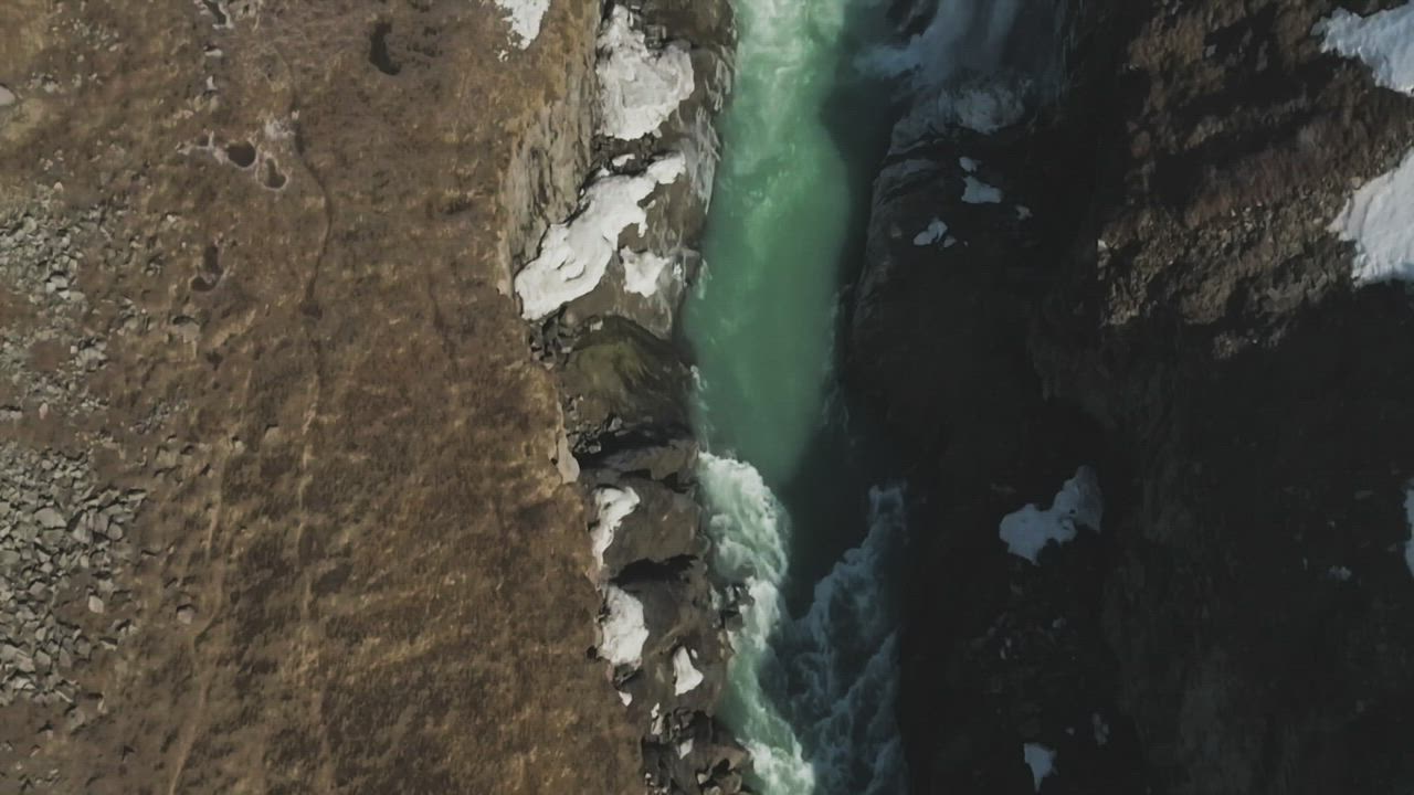 Water falling into a river - Free Stock Video