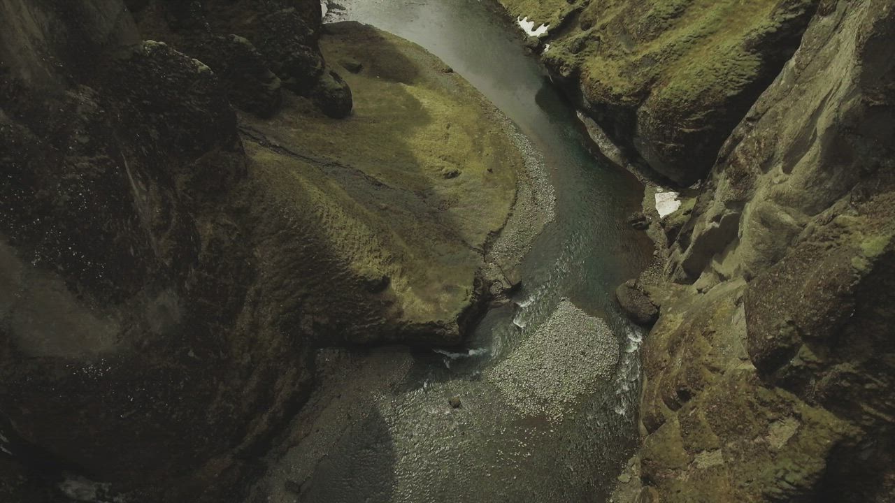 Shallow river flowing through a canyon - Free Stock Video