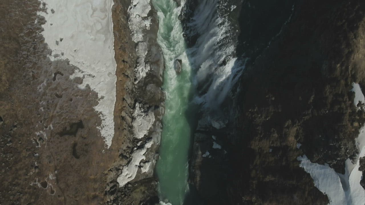 Freezing water breaking over a waterfall - Free Stock Video