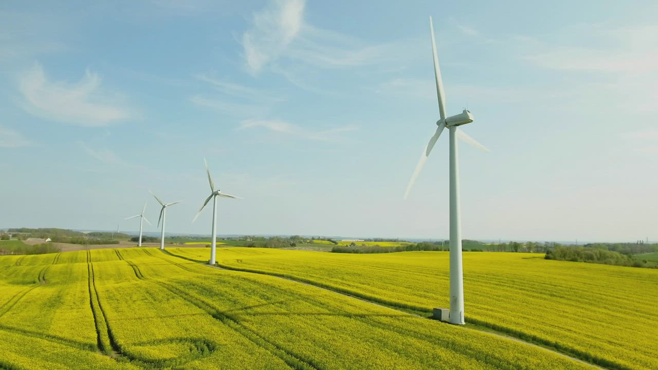 Wind turbines in a field - Free Stock Video