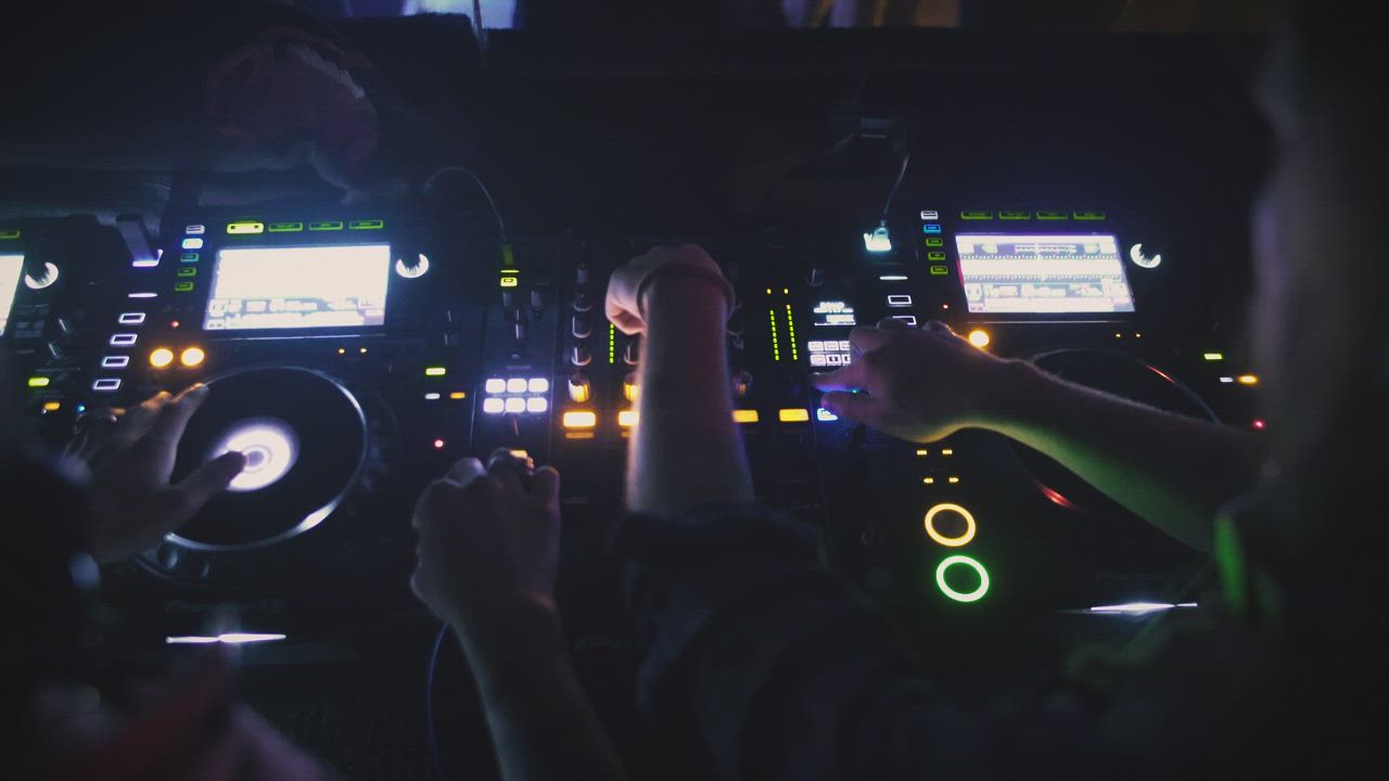 Two DJs mixing music at a club - Free Stock Video