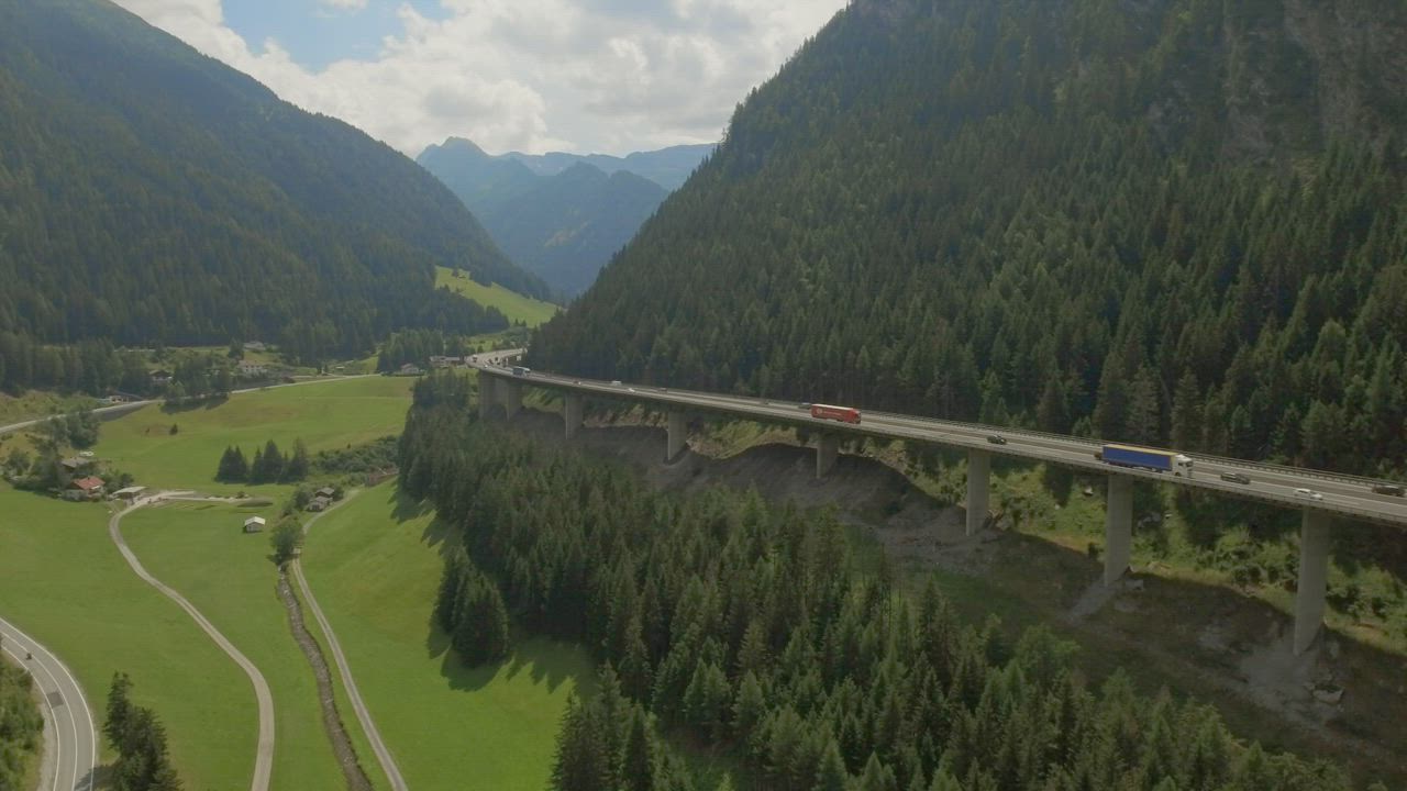 Freeway on a bridge next to a mountainous landscape - Free Stock Video