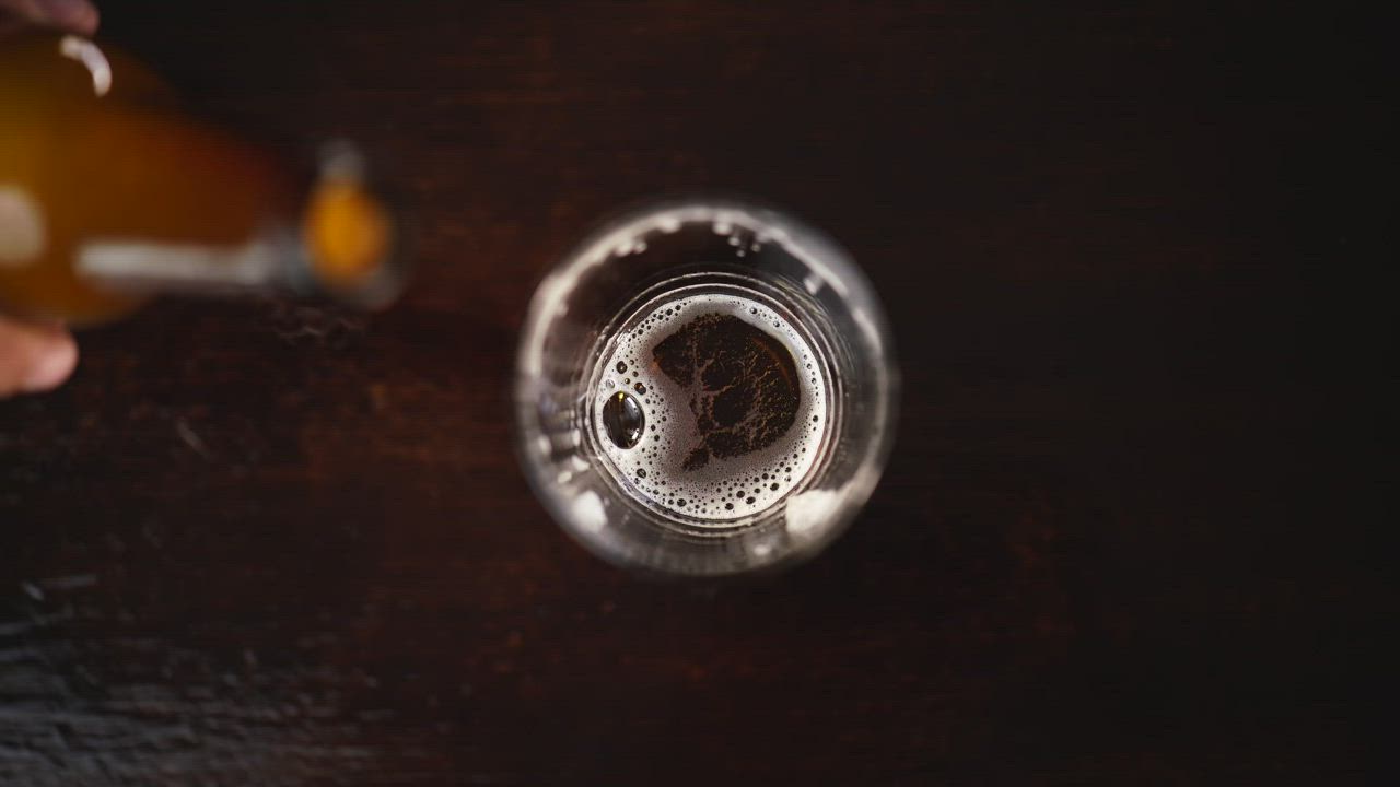 Serving beer in a glass, top shot - Free Stock Video