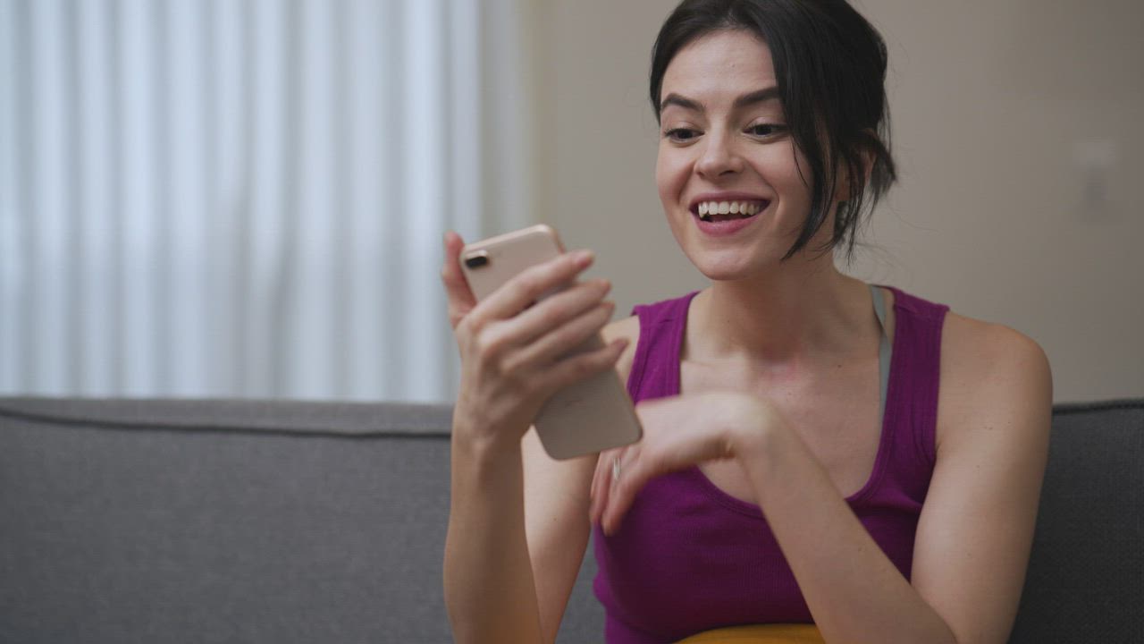 Excited girl talking on video call with her cell phone - Free Stock Video