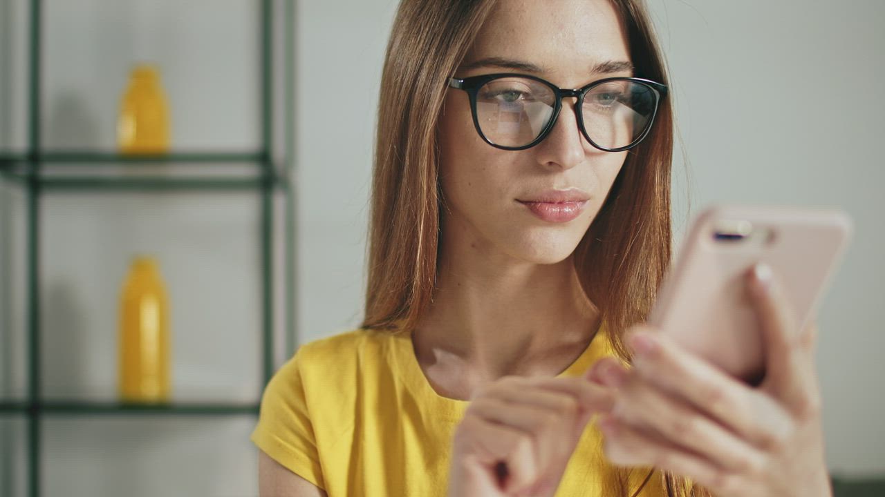 Young woman using smartphone app touchscreen - Free Stock Video