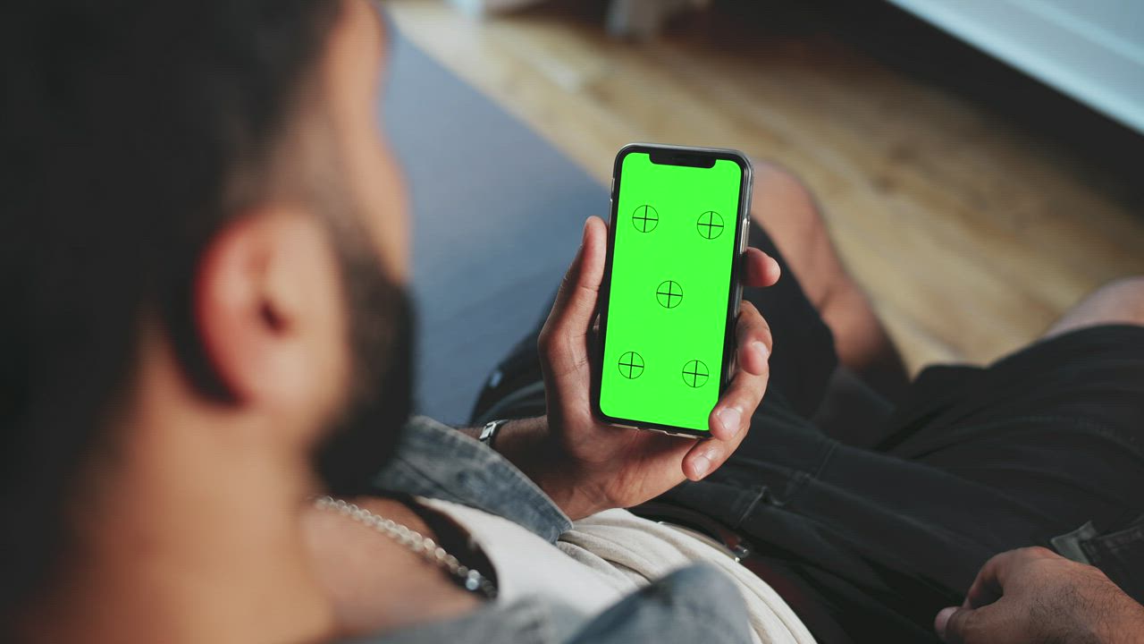 Man browsing website on mobile greenscreen - Free Stock Video