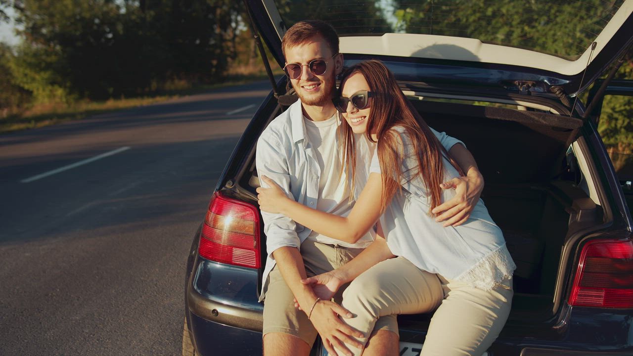 Happy couple enjoy romantic sunset in car - Free Stock Video