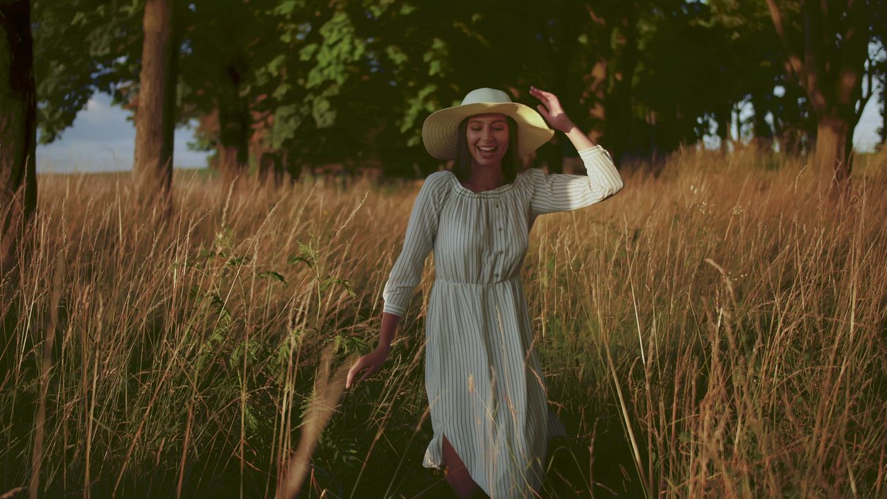 Woman running free through country field - Free Stock Video