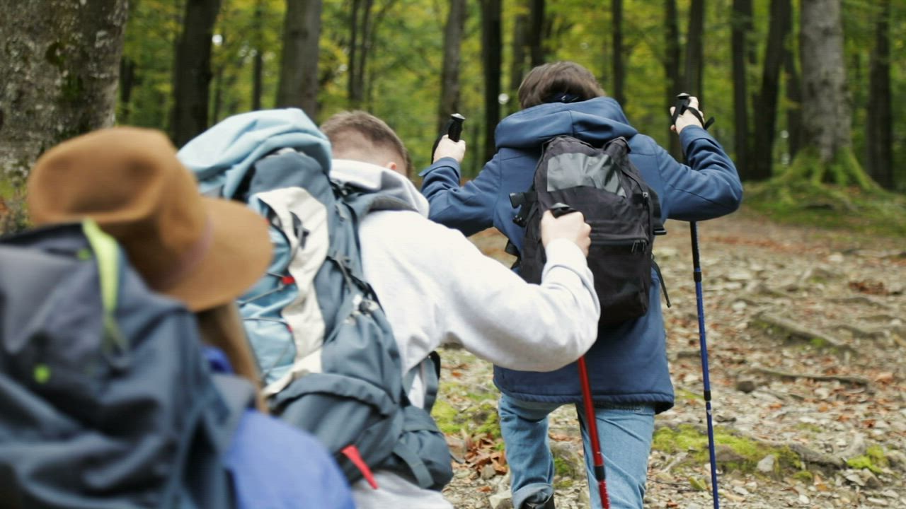 Cinematic view of friends hiking rough terrain - Free Stock Video