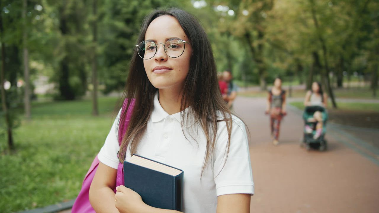 Smiling student inspired by nature in park - Free Stock Video